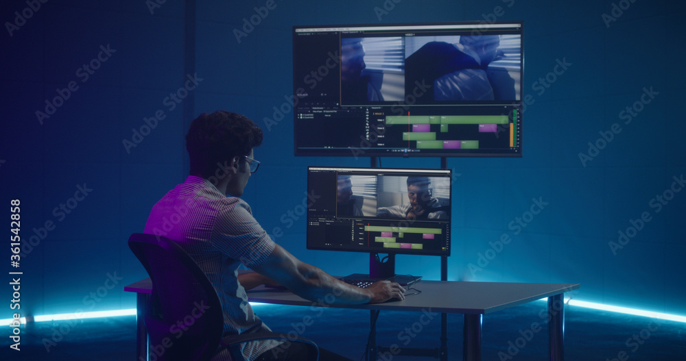Foto de Video editor at work in editing room do Stock | Adobe Stock