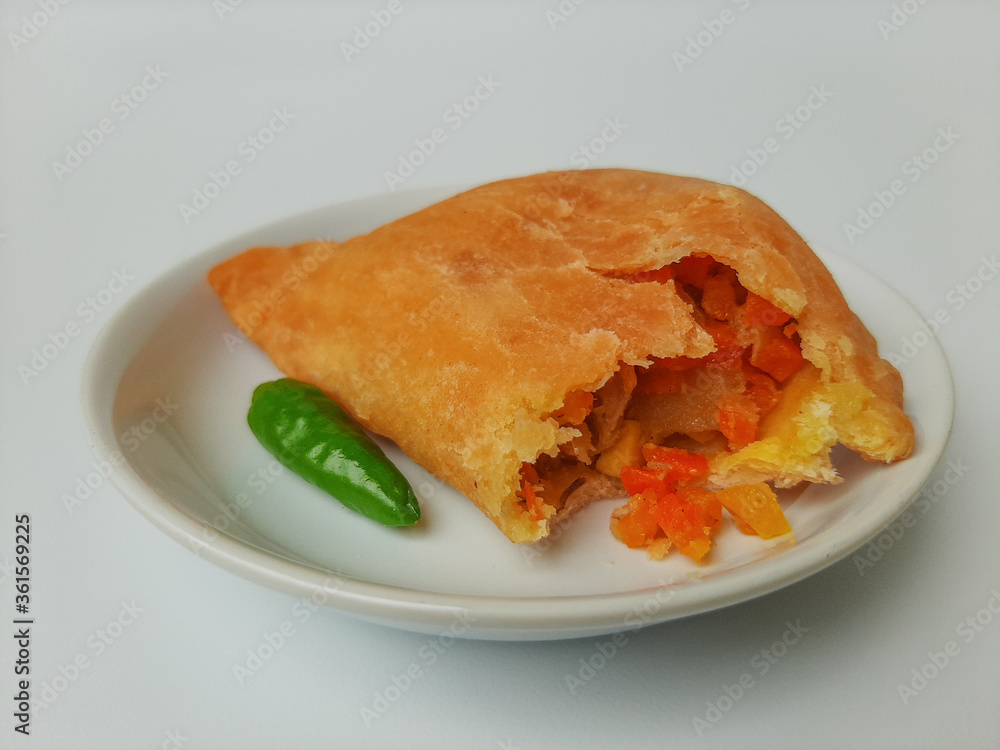 Bitten pastel. Pastel is a popular snack from Indonesia. A pastry ...