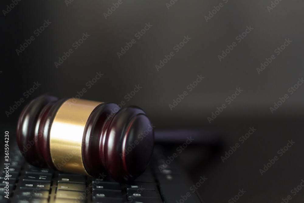 Judge's gavel on computer keyboard on black background with copy space ...