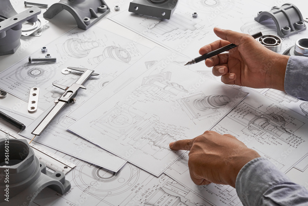 Engineer technician designing drawings mechanical parts engineering ...