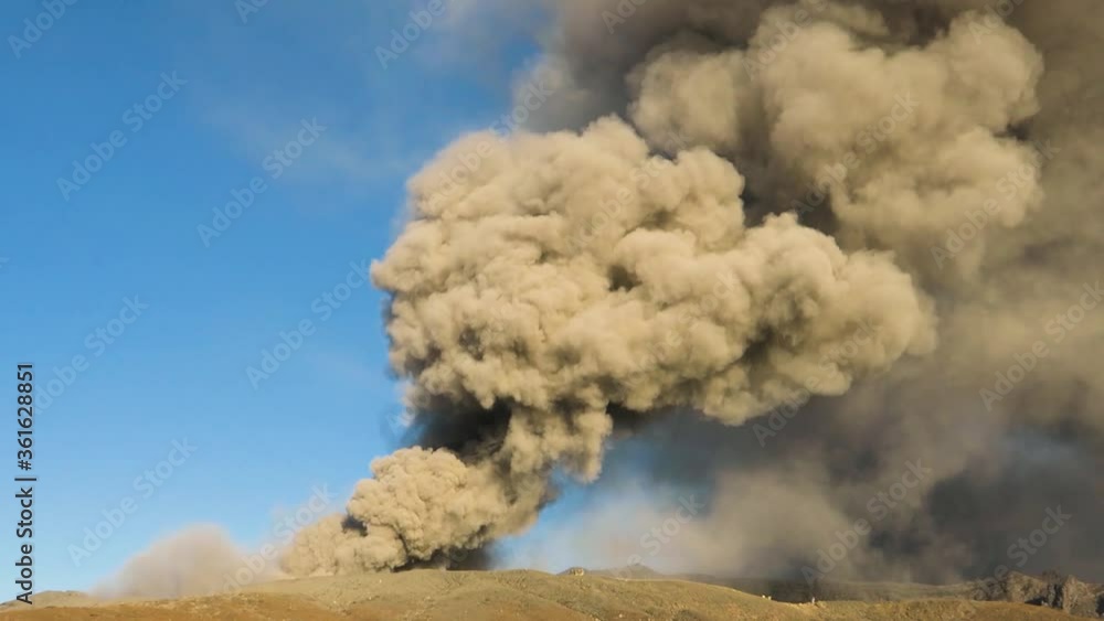 Mount Aso volcano during eruption, releasing ash and steam, close view ...