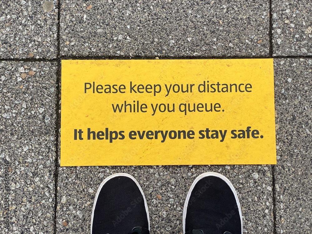Sign stuck to the floor outside a supermarket to encourage social ...