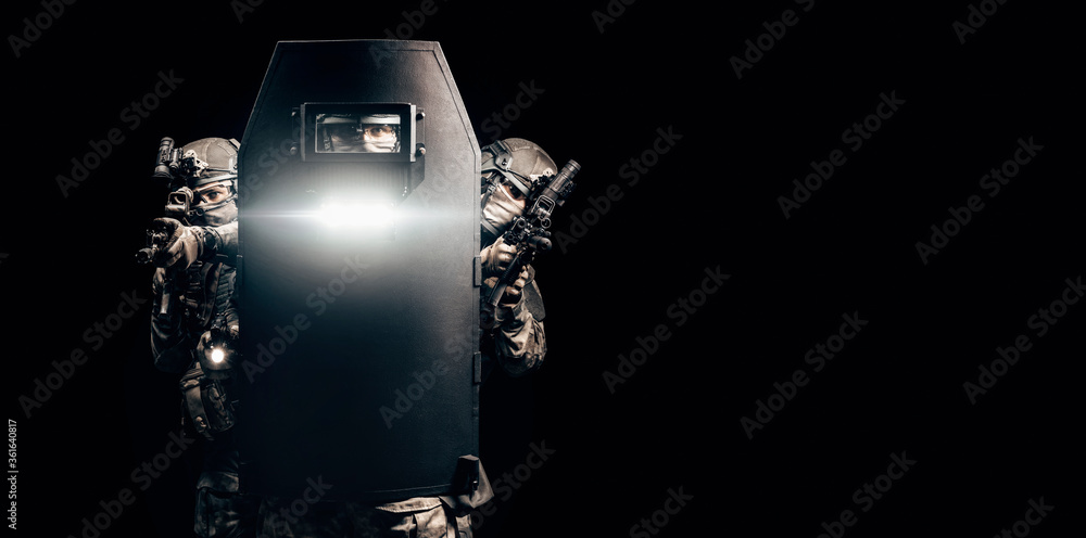 Portrait of a group of fighters of a special unit. They hide behind a ...