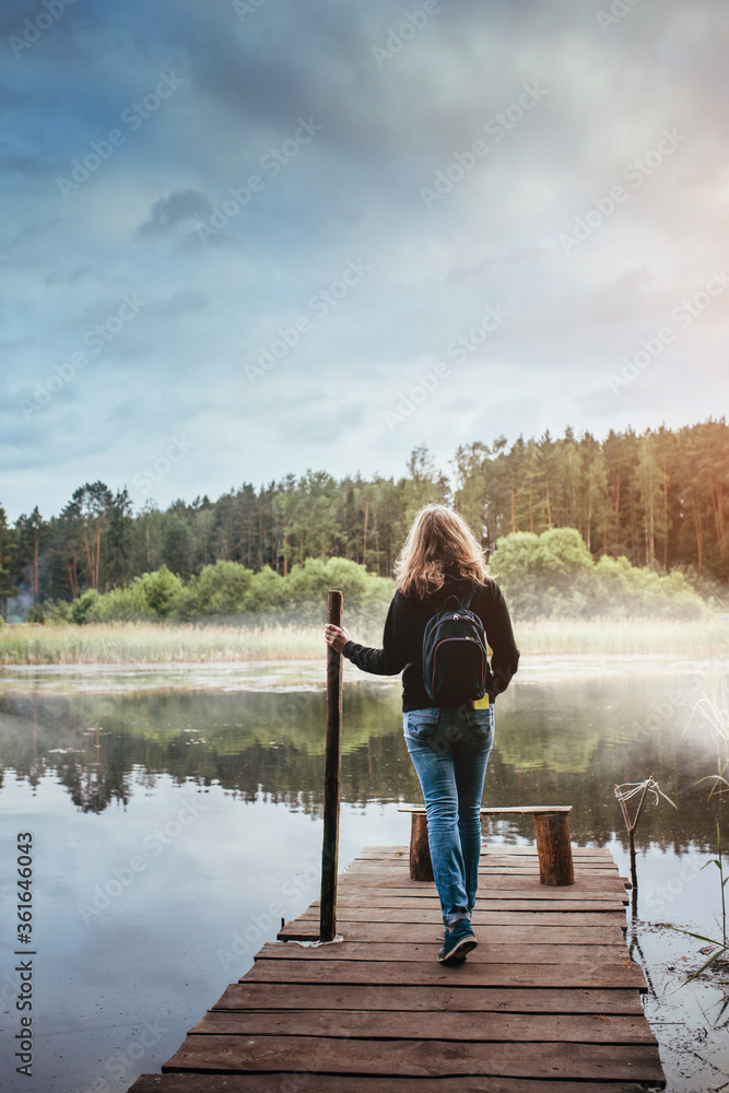 Paradise morning walk in the forest - the girl went on a wooden pier ...