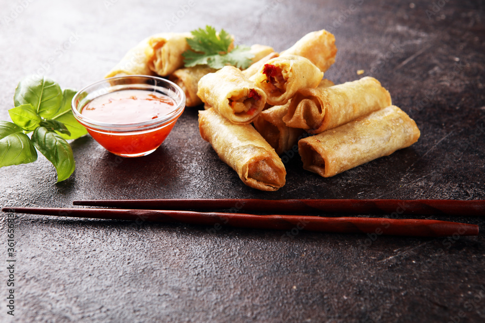 Fried chinese spring rolls with sweet chili sauce on rustic background ...