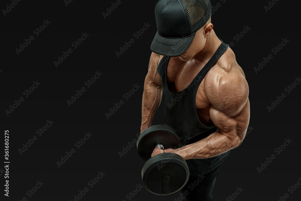 Close up shot of muscular bodybuilder wearing a red tank top and black ...