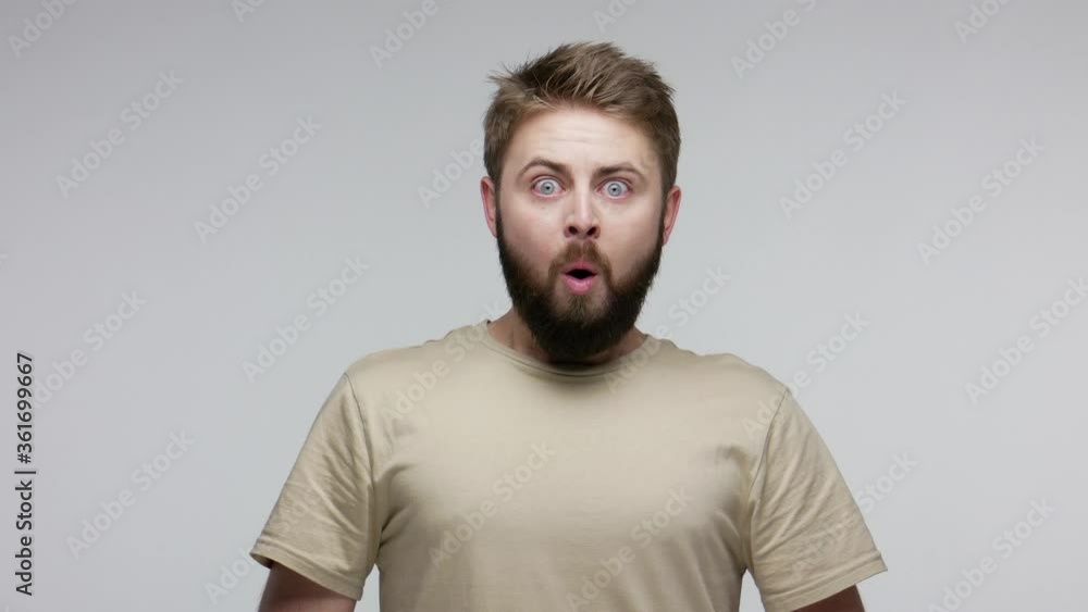 Wow, unbelievable! Bearded man feeling shocked astonished and looking ...