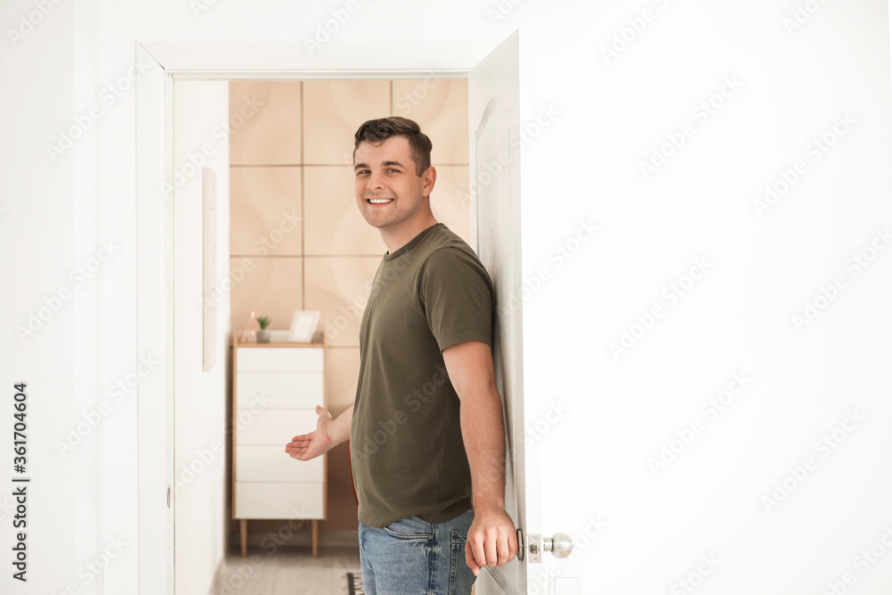 Happy man inviting guest at his new home Stock Photo | Adobe Stock