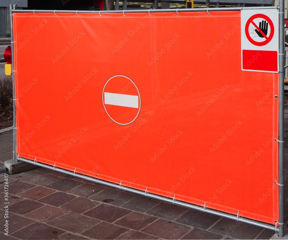 Red plastic tarpaulin with painted a no entry sign in the center, used ...