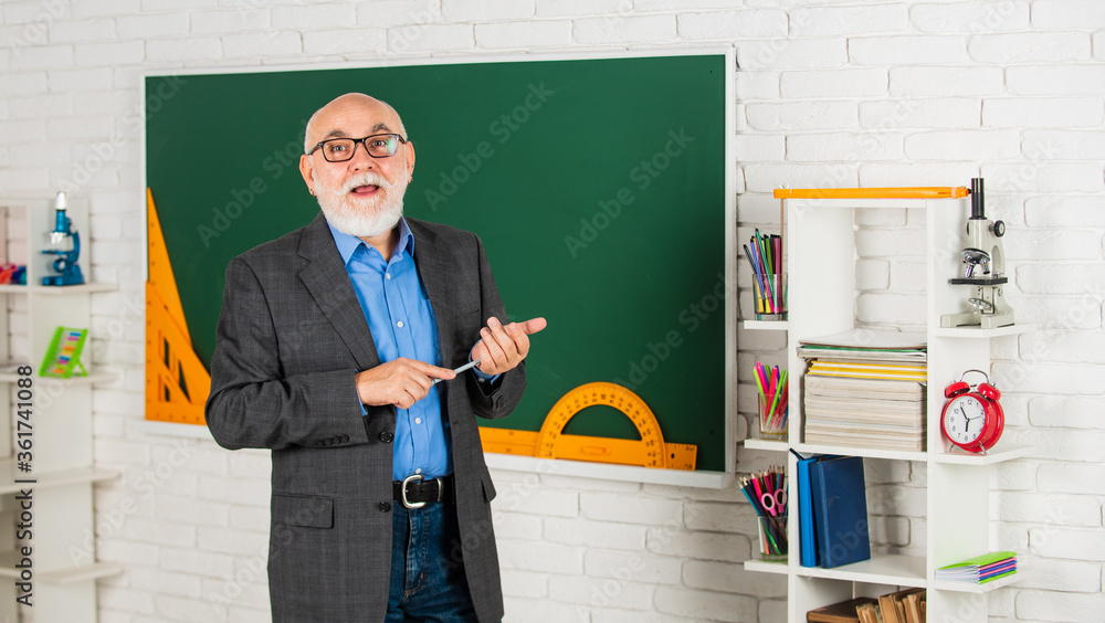 level of maths. senior man teacher use tool at blackboard. bearded ...