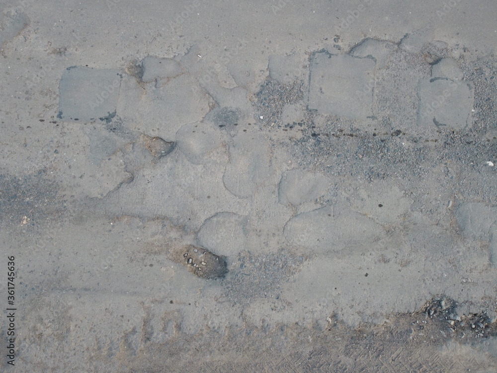 Foto de Potholes on the asphalt. Background of a broken road with ...