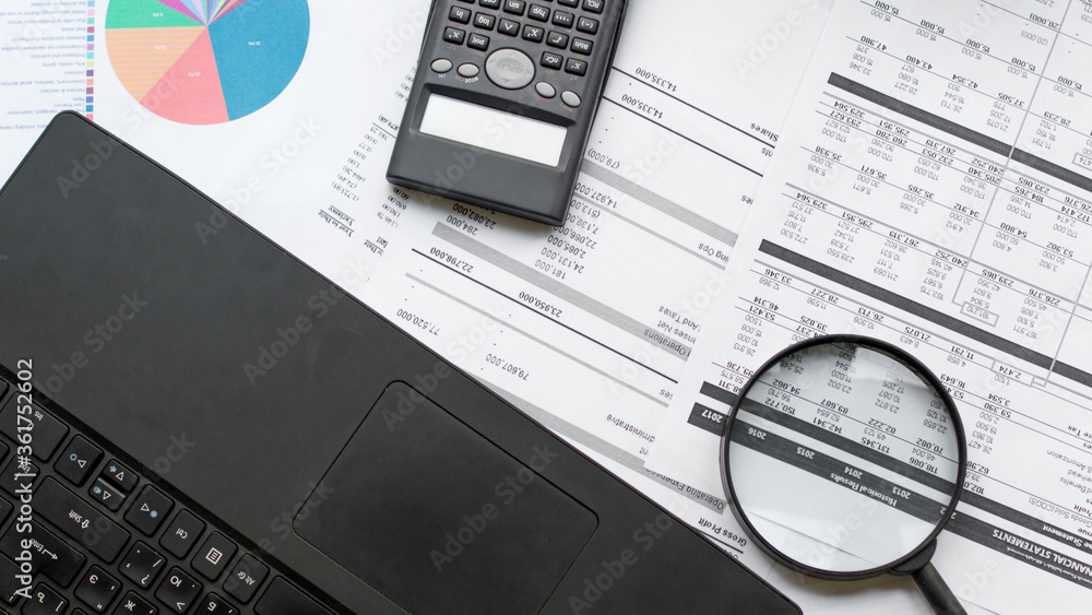 Financial documents - graphics, statistics, drawings, keyboard, laptop ...