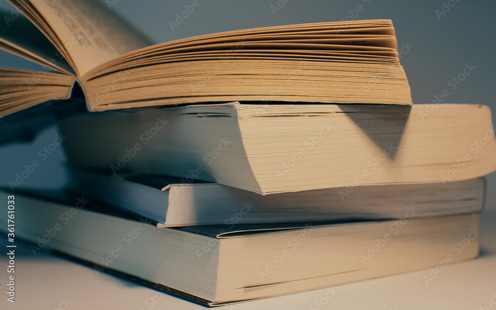 stack of books with an open book on top Stock Photo | Adobe Stock