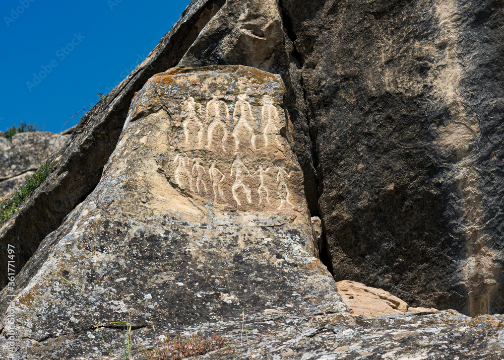 Ancient rock carvings petroglyphs in Gobustan National park. Exposition ...