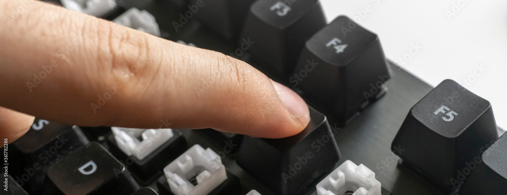 gamer push the button on a mechanical keyboard with mechanical switches ...