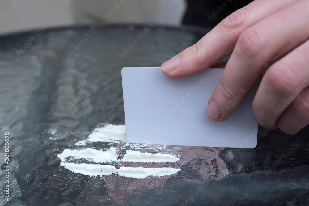 Dose of drugs and the hand of an addict, close-up. Addiction concept ...