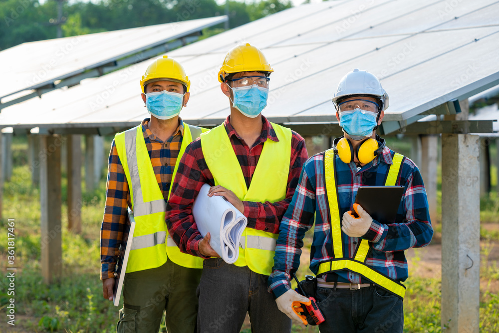 Solar power plant,Electrician wearing a medicine healthcare mask ...