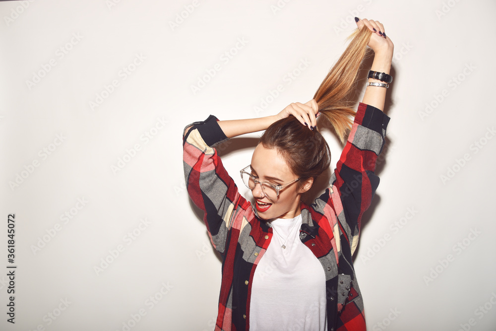Beautiful girl holds her hair in her hands and rejoices, model and ha ...