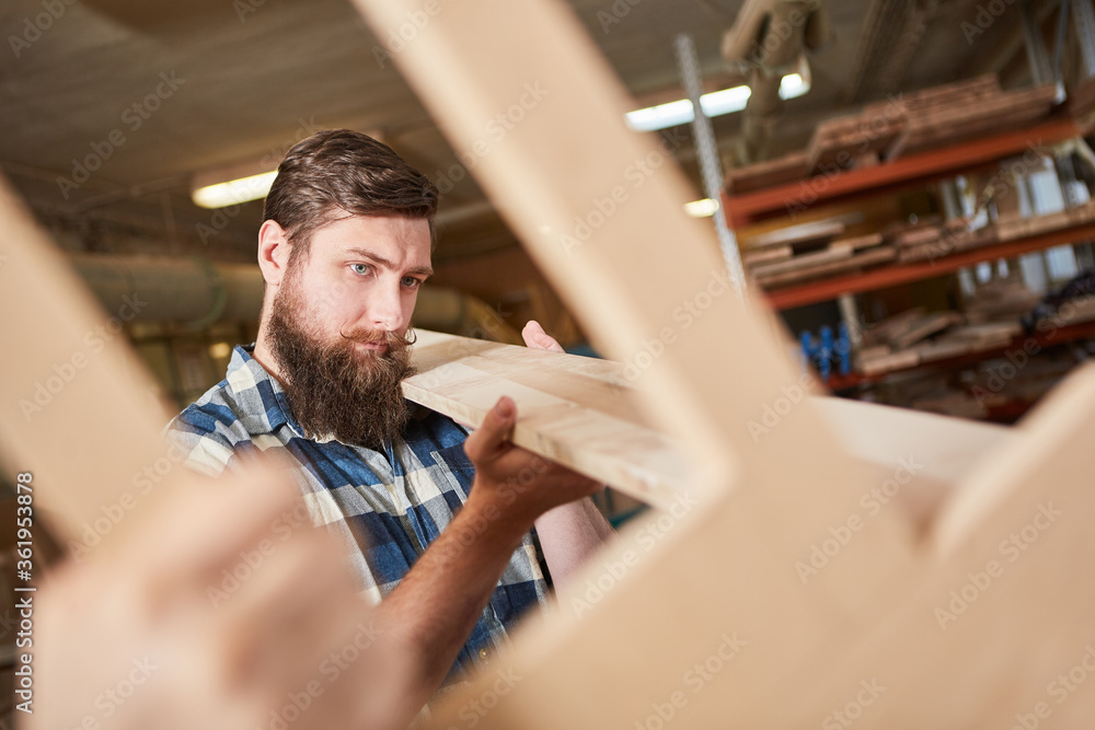 Hipster carpenter in training with lumber Stock Photo | Adobe Stock