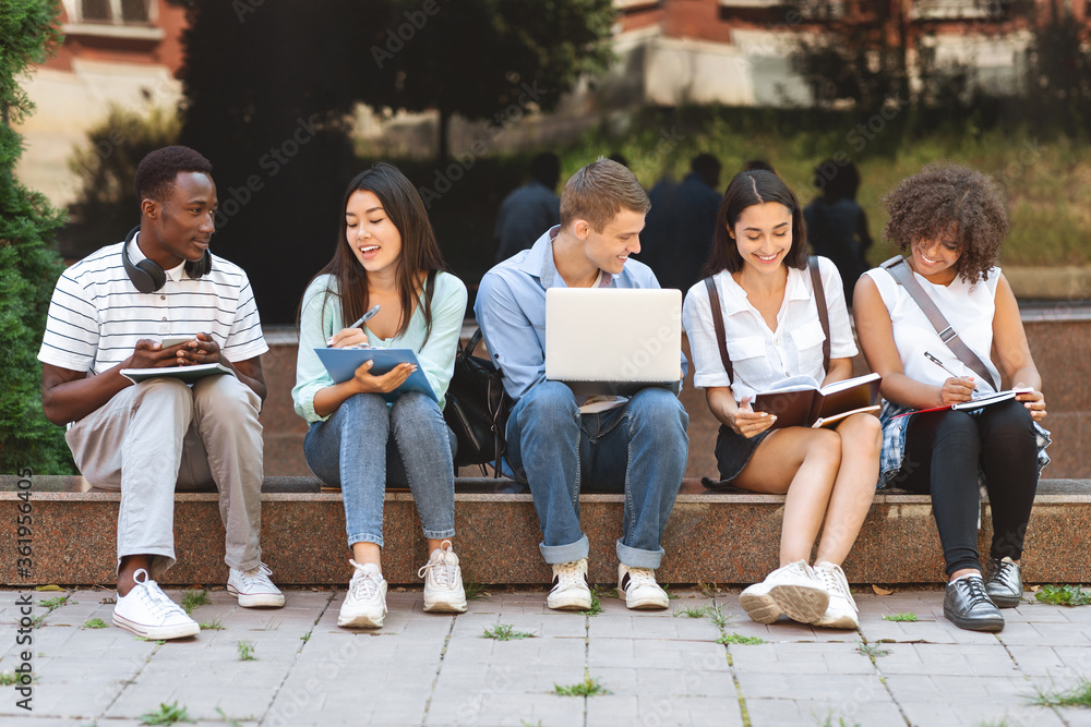 Group of happy teen high school students studying outdoors Stock Photo ...