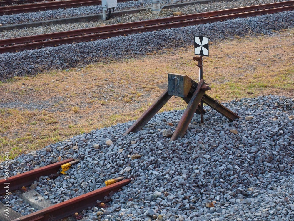 view of dead end railway track. sign at the end of the rail trail ...