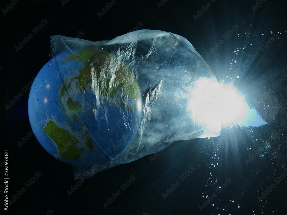 world in plastic bag drifting underwater representing ocean pollution ...