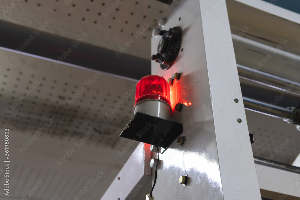 blurred low key Illuminated factory industry red alert emergency light ...