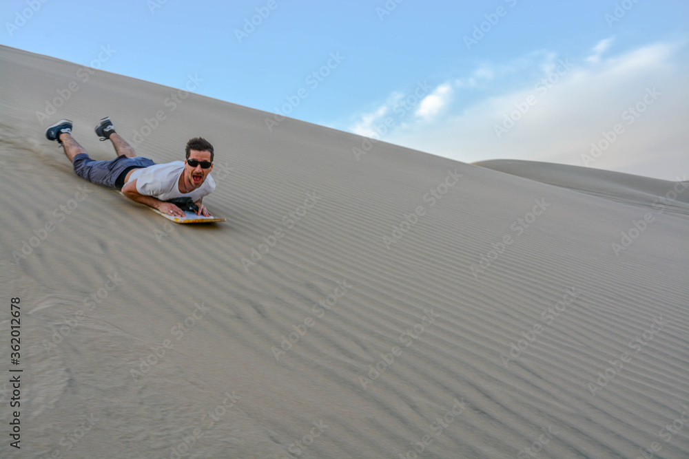 Doing sandboard in Huacachina, Peru Stock Photo | Adobe Stock