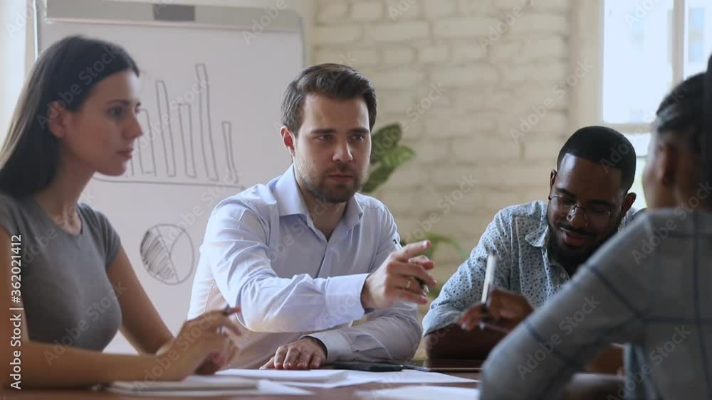 Male corporate leader boss mentor talking to multiracial staff workers ...