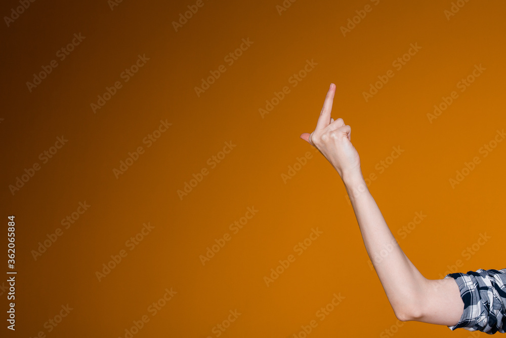 Female hand shows the middle finger on the right of the screen on an ...