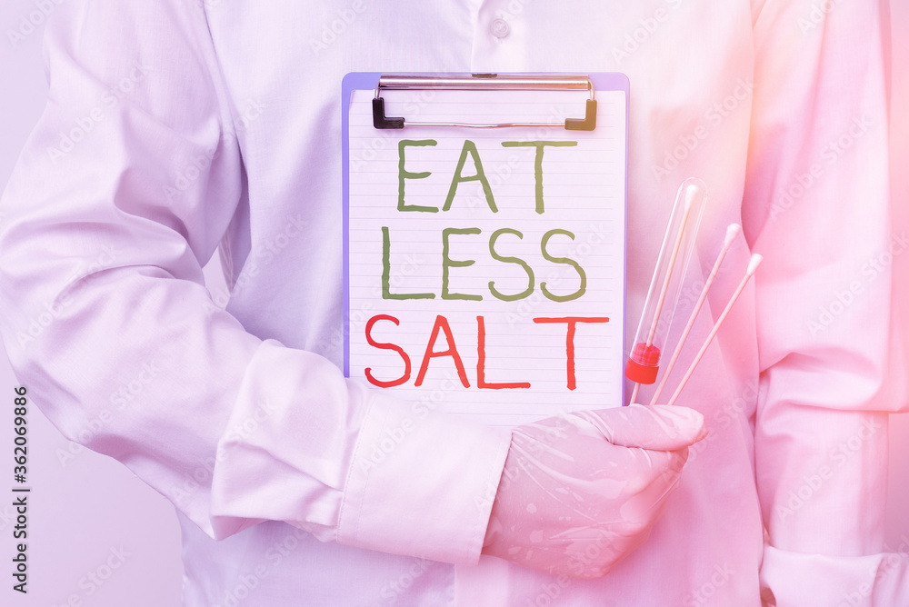 Writing note showing Eat Less Salt. Business concept for reducing the ...