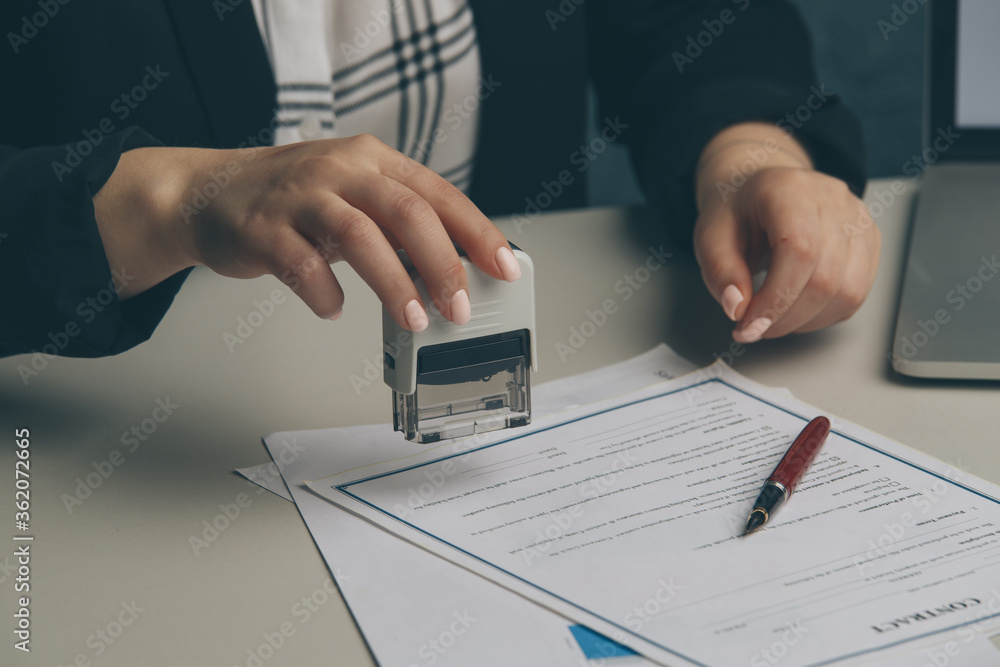 Female notary stamping agreement, company secretary, official document ...