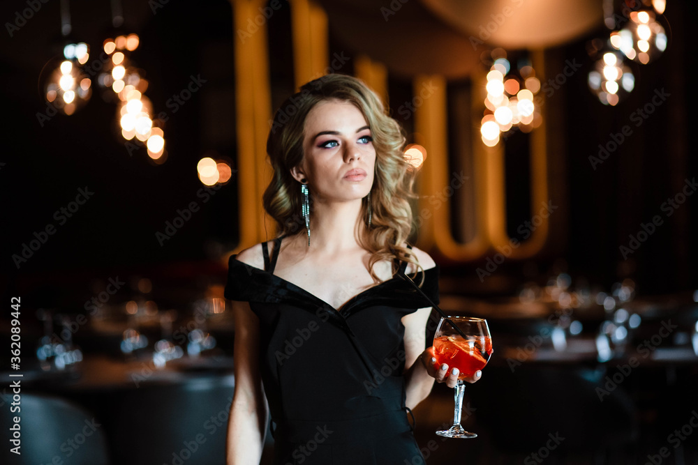 Beautiful Blonde Young Girl Holding An Aperol Spritz Cocktail Aperol