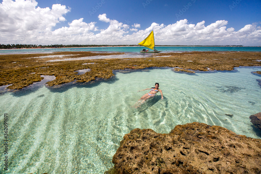 Woman swimming and relaxing on natural pool in Porto de Galinhas ...