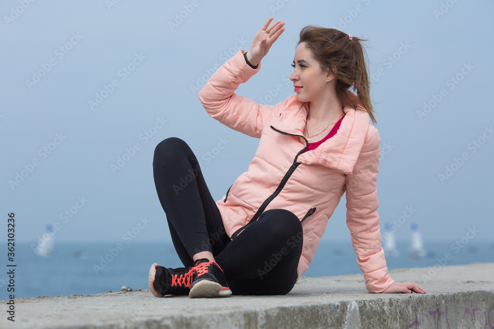 Girl sitting cross-legged outdoors Stock Photo | Adobe Stock