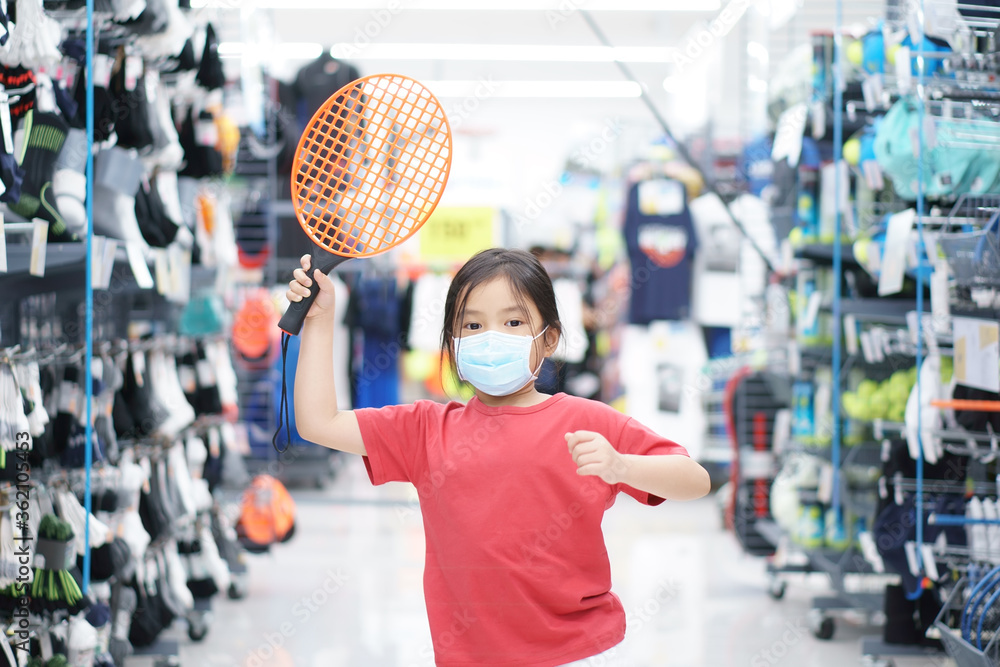 Asian child exercise or kid girl wear face mask with holding small ...