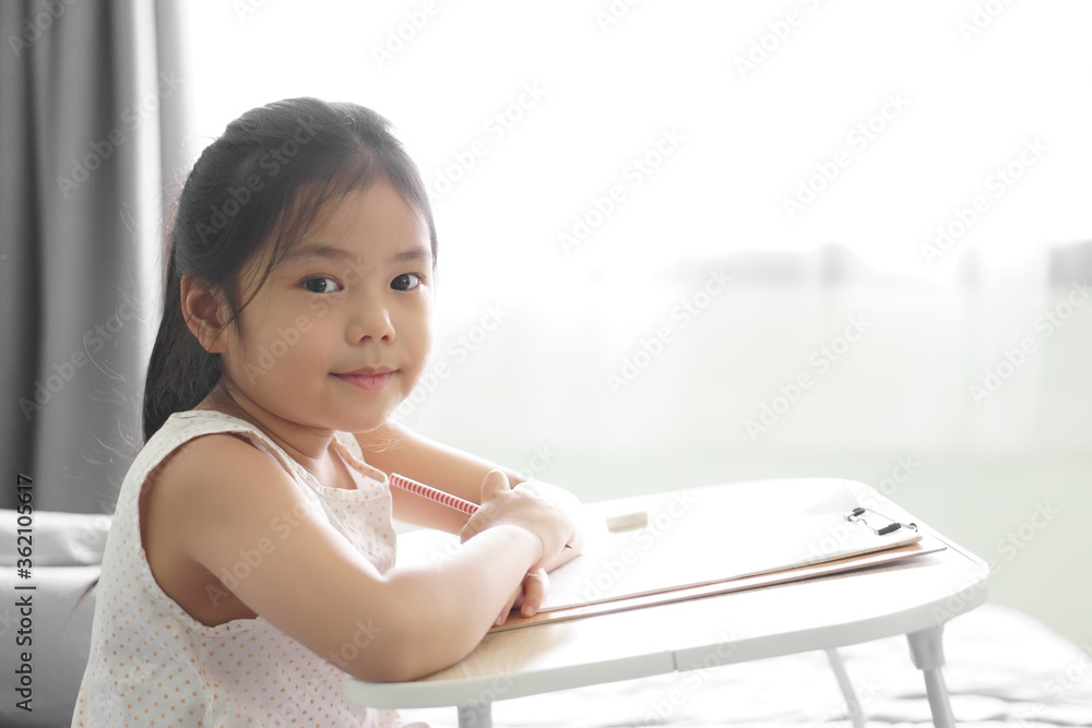 asian child cute or kid girl smiling writing or drawing and enjoy doing ...