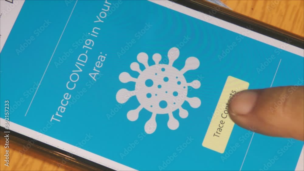 Overhead medium view of COVID-19 virus tracing app with user tapping ...