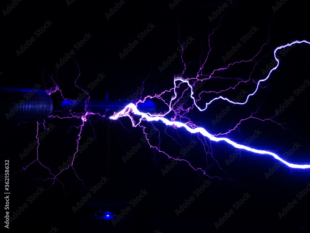 Bright white-blue electric lightning emanates from electric coils in ...