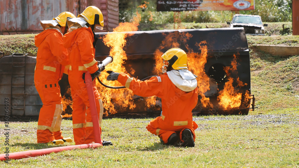 Firefighter fighting with flame using fire hose chemical water foam ...