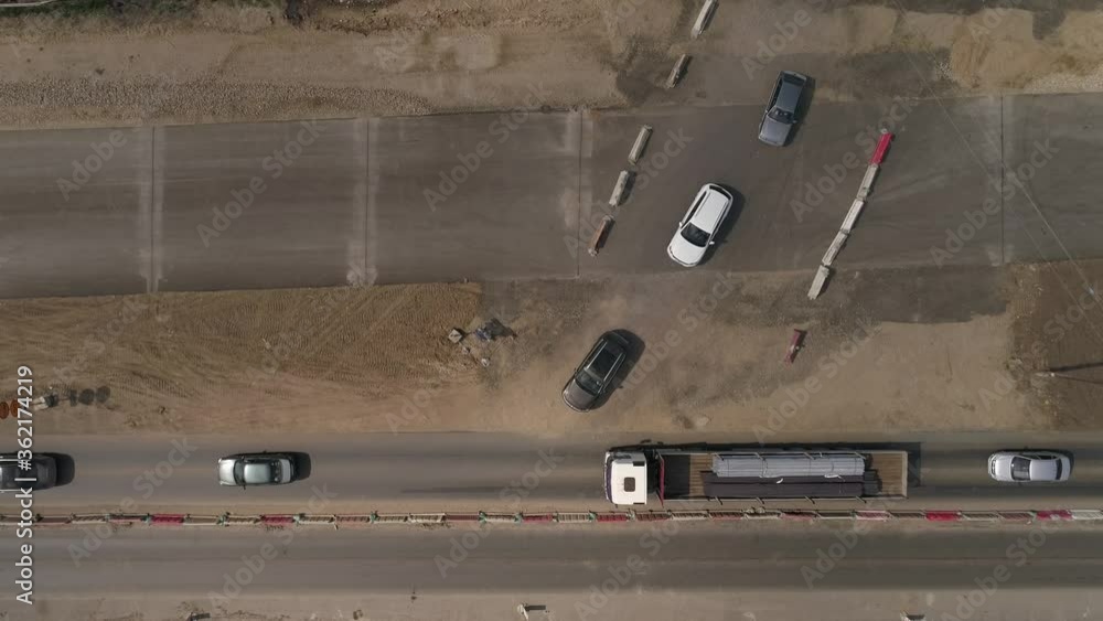 07. Top down aerial view of construction of a highway section. Cars are ...
