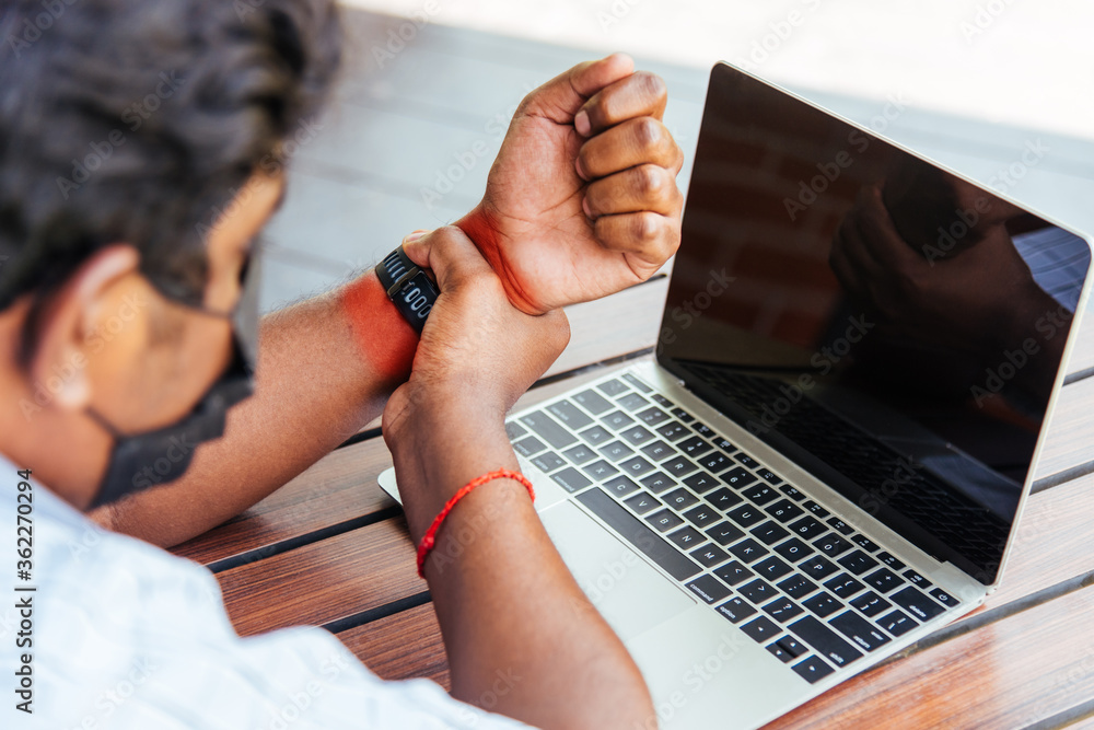 Closeup hands the Asian black man holding his wrist pain from using ...