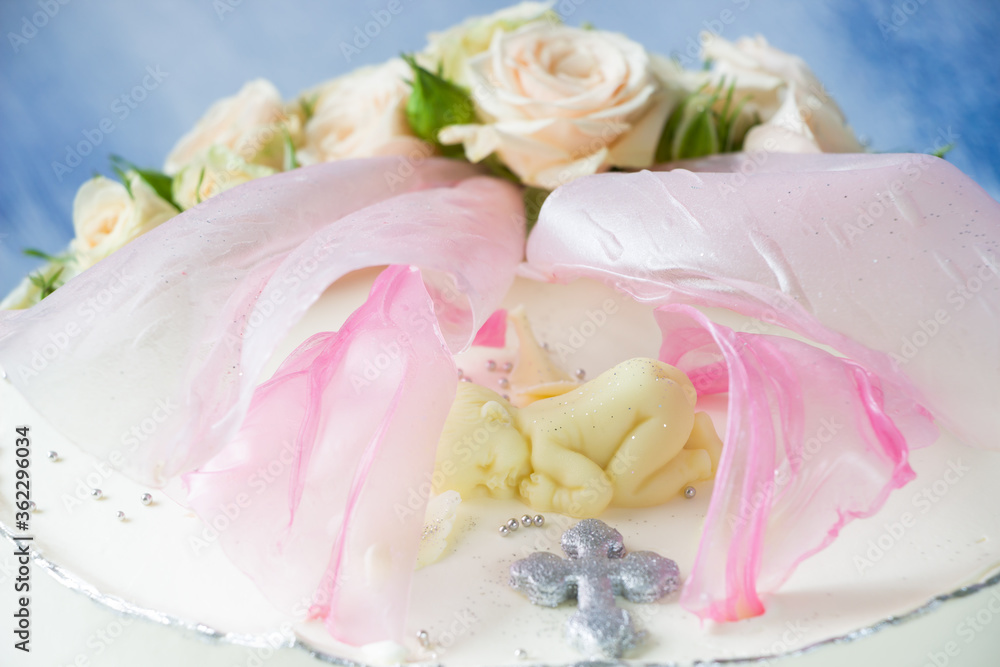 Christening cake for baby girl, white cake with pink wings, chocolate baby figure and pink roses ...