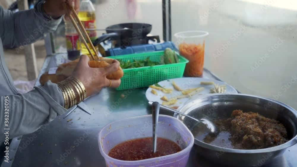 View of Vietnamese female hands making delicious authentic banh mi ...