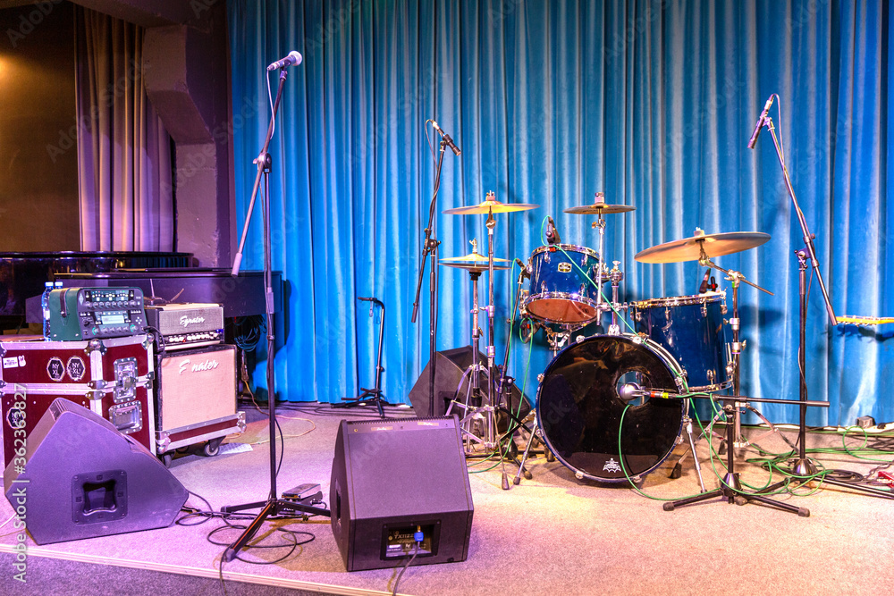 Variety drum set and tube sound amplifier on the scene of a night club ...