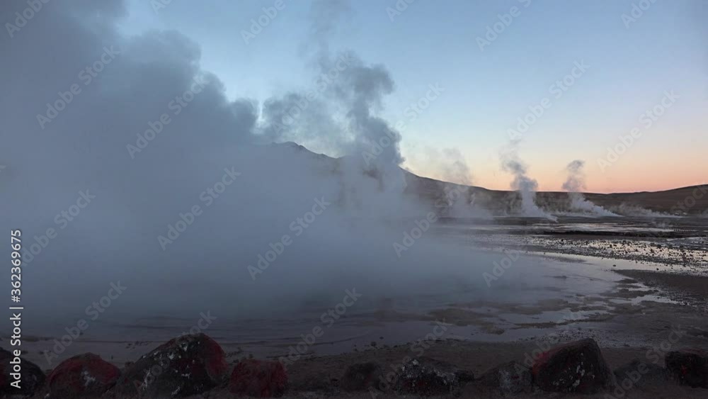 Chile. Spring with natural thermal water produces hot steam at sunrise ...