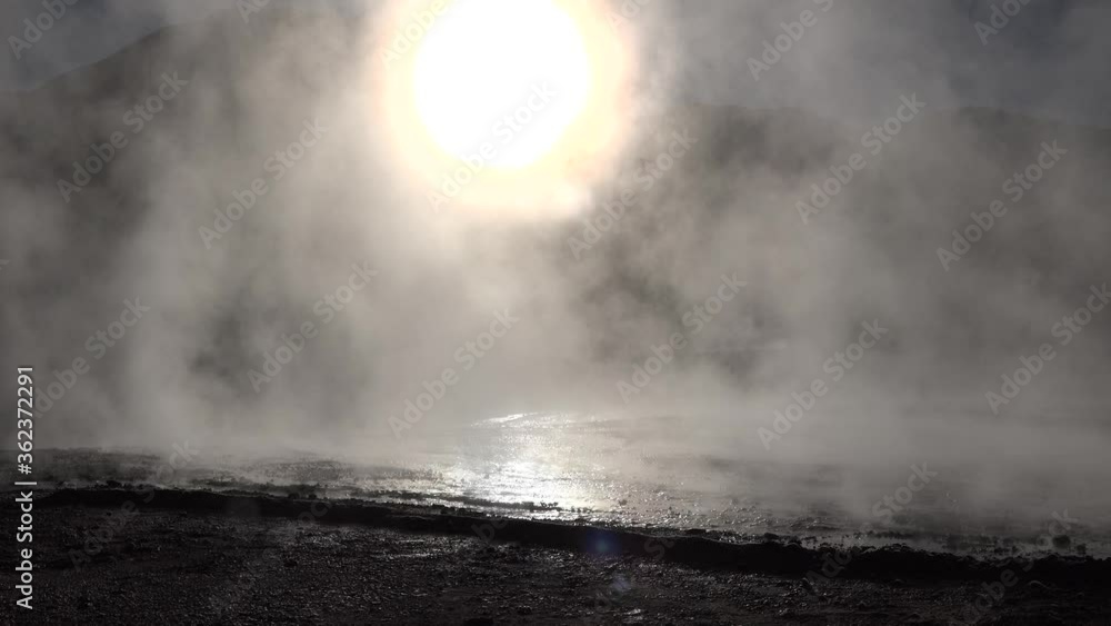 Chile. Spring with natural thermal water produces hot steam at sunrise ...