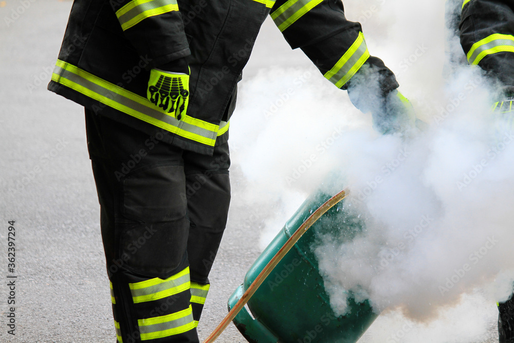 Two firefighter or fireman help and using fire extinguisher spraying ...