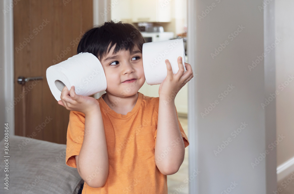 Happy young boy with smiling face playing with toilet paper, kid ...