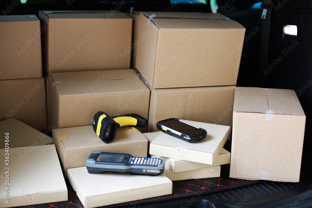 logistic scaner and mobile scaner with pacel in car, delivery concept ...